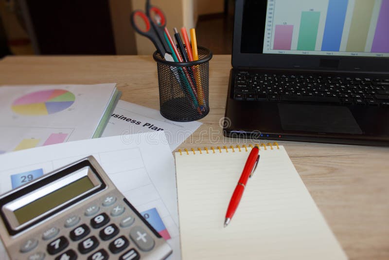 Close Up Detail View of a White Work Desk with a Laptop Computer and a ...