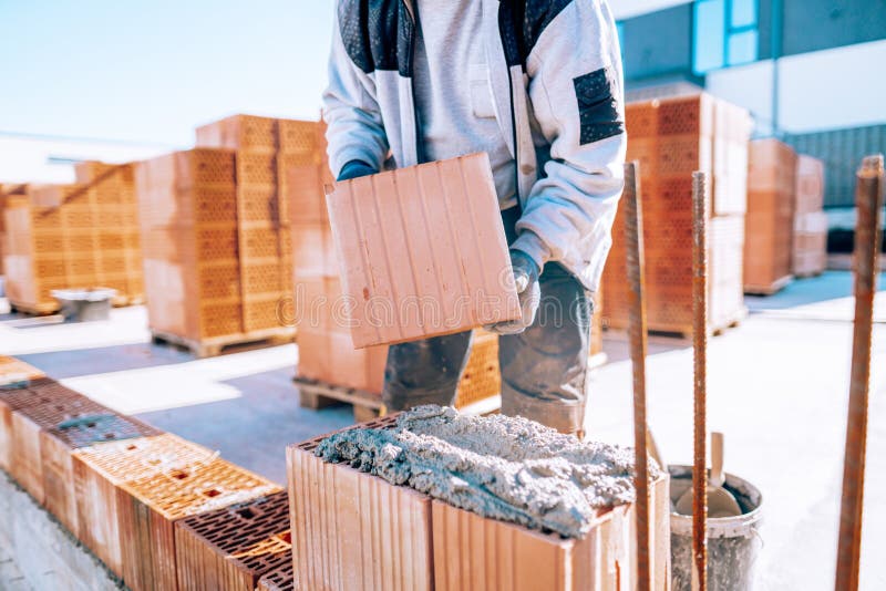 Close Up of Industrial Bricklayer Installing Bricks on Construction ...