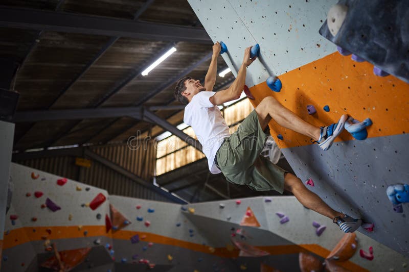 Close Up of Determined Man Tackling Climbing Wall at Indoor Activity ...