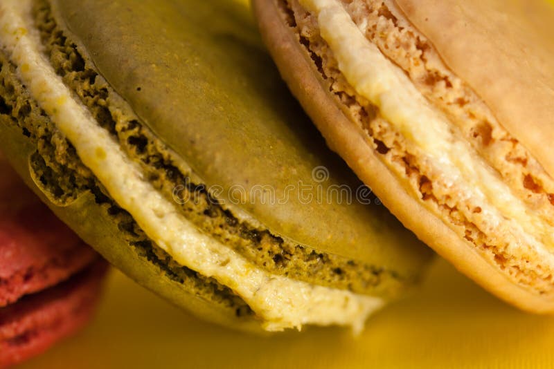 Close Up of Different Big Macaroons Over Yellow Background Stock Photo ...