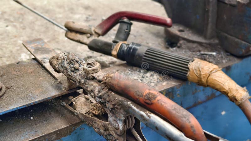 Close-up of Dirty Welding Clamp and Electrode Holder on Workbench ...