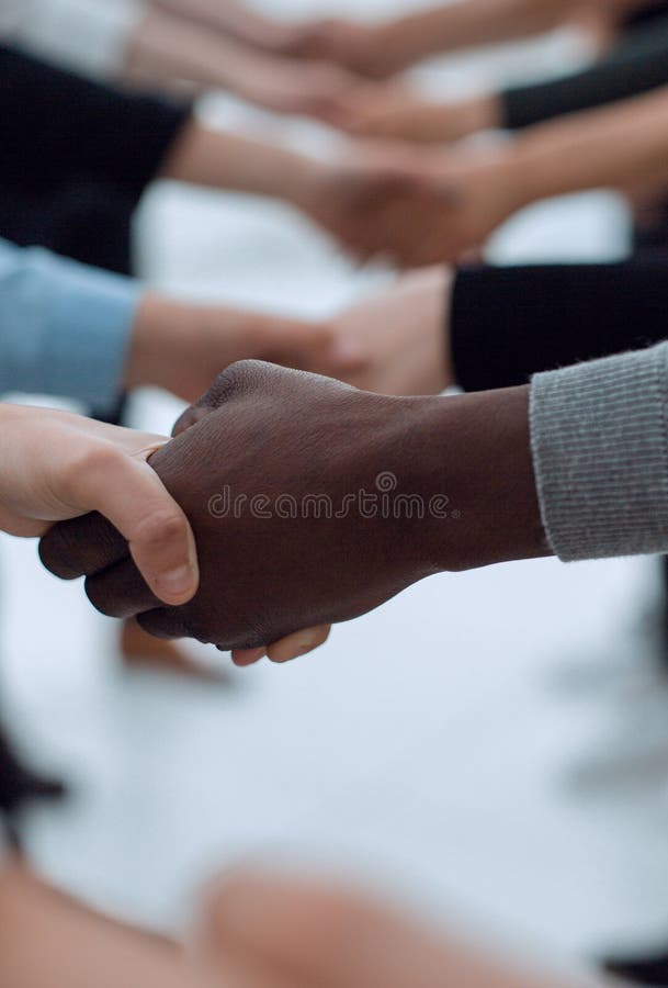 Close Up. Diverse Young People Shaking Hands with Each Other Stock ...