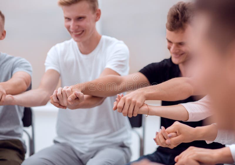 Close Up. Diverse Young People Taking Each Other`s Hands Stock Photo ...