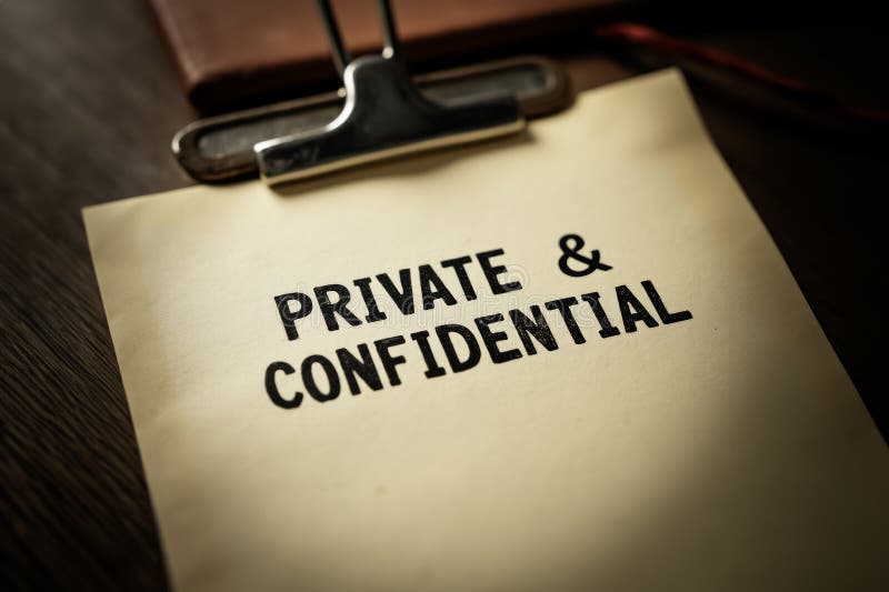 Private and Confidential Document on Clipboard with Subdued Lighting ...