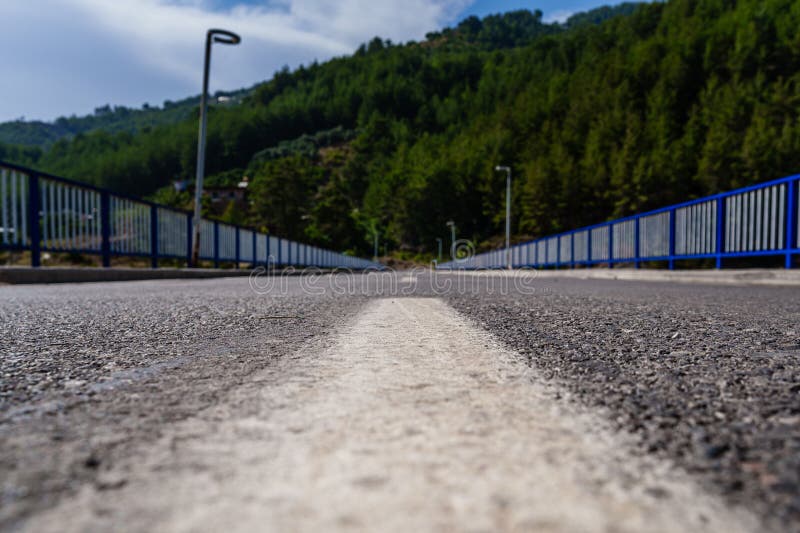 Close Up Down of an Empty Asphalt Bridge Road Behind a Green Forest ...