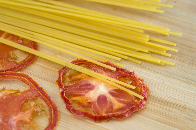 Close-Up of Dried Red Tomatoes and Spaghetti on Wood Counter Stock ...
