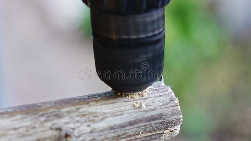 Close-up. the Drill Makes a Hole in the Poles for the Construction of ...