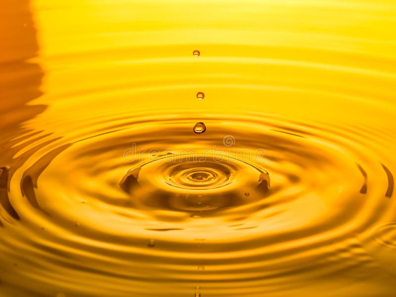 Close Up of a Drop Oil on a Yellow Background Stock Photo - Image of ...