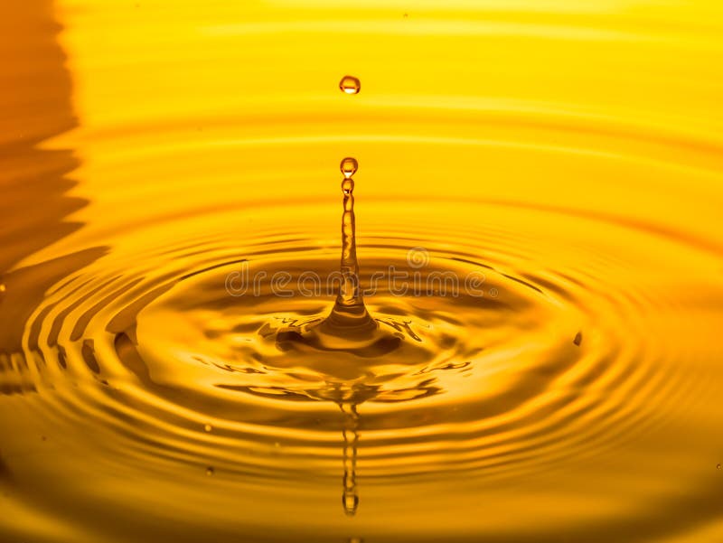 Close Up of a Drop Oil on a Yellow Background Stock Photo - Image of ...