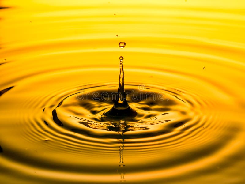 Close Up of a Drop Oil on a Yellow Background Stock Image - Image of ...