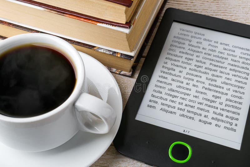 Close-up of E-book Reader Near Cup of Hot Coffee and Stack of Ordinary ...