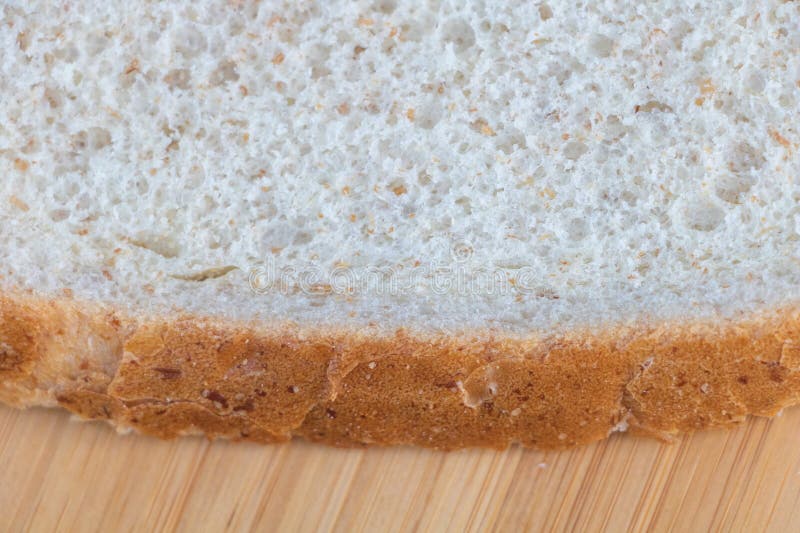 Close-up of the Edge and Texture of White Bread Slice on Wooden Table ...