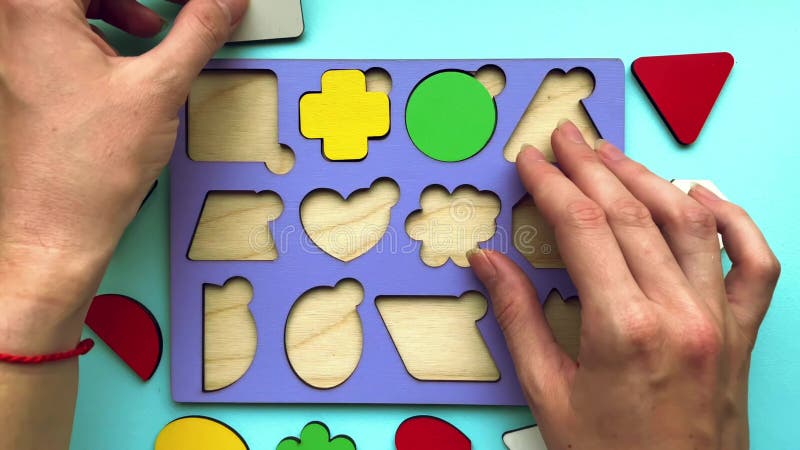 Close-up of an Educational Toy with Inserts, with Female Hands ...