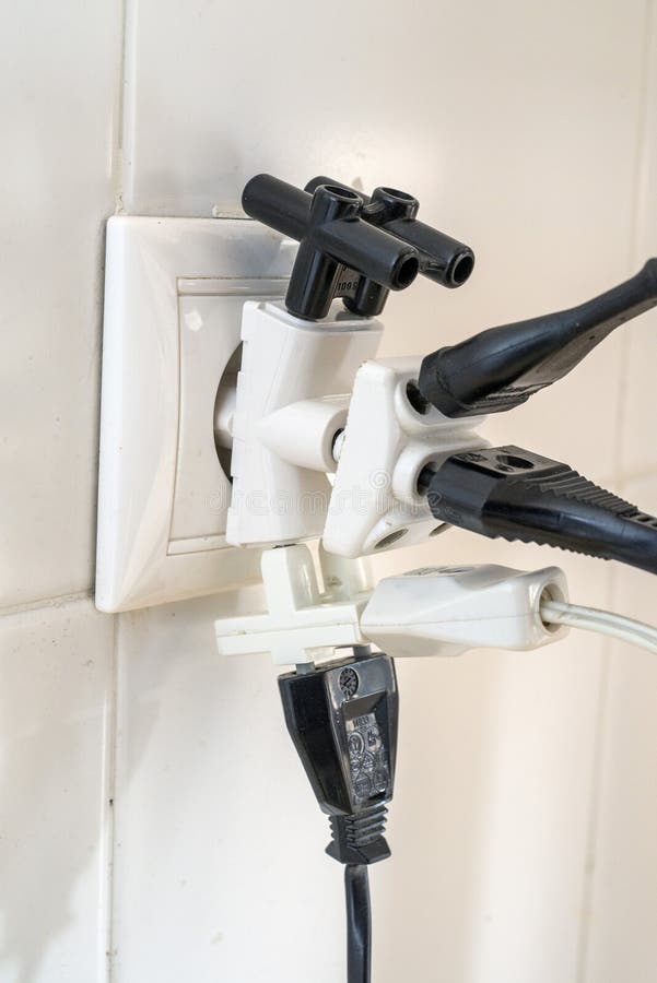 Close-up of Electrical Outlet with Multiple Plugs Connected Stock Photo ...