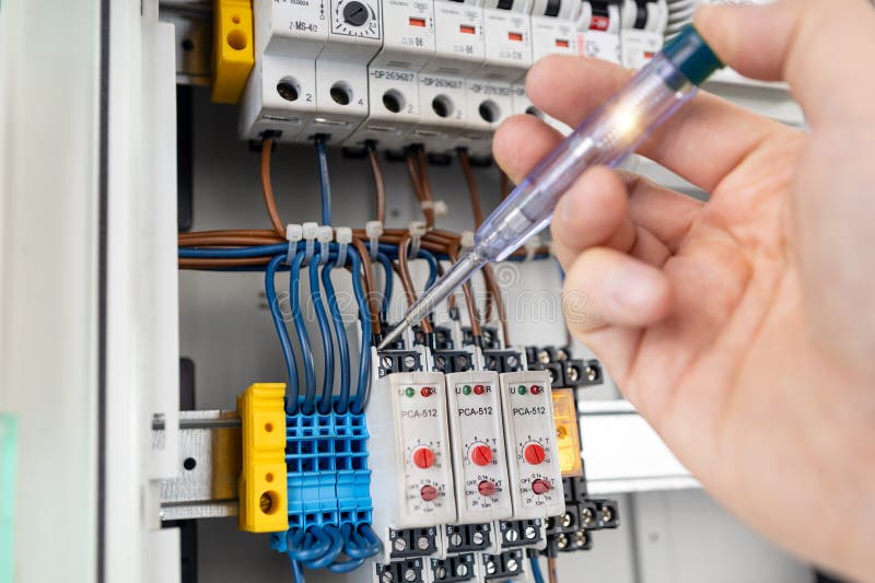 Electrician Testing Electrical Connections with Voltage Tester in ...