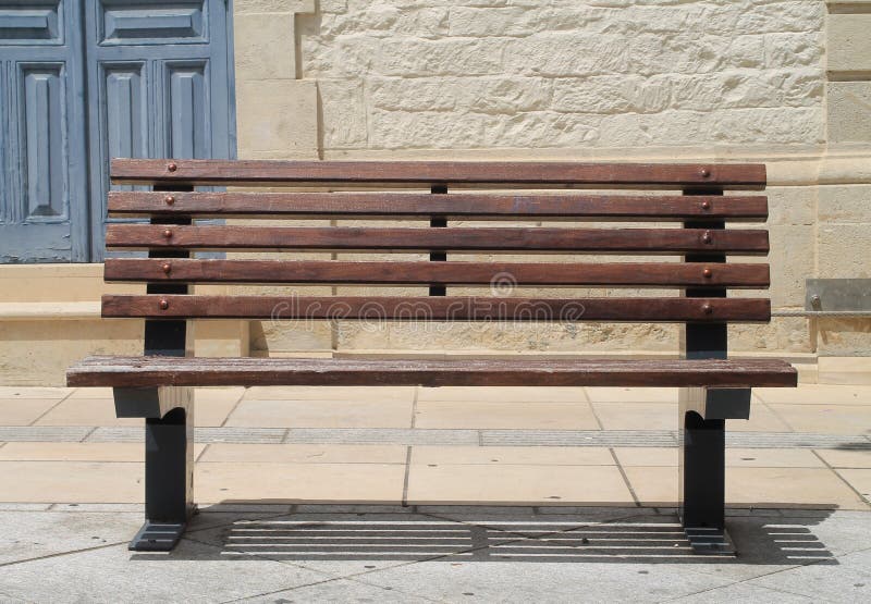 Empty Bench in Front of Stone Wall Stock Image - Image of bench ...