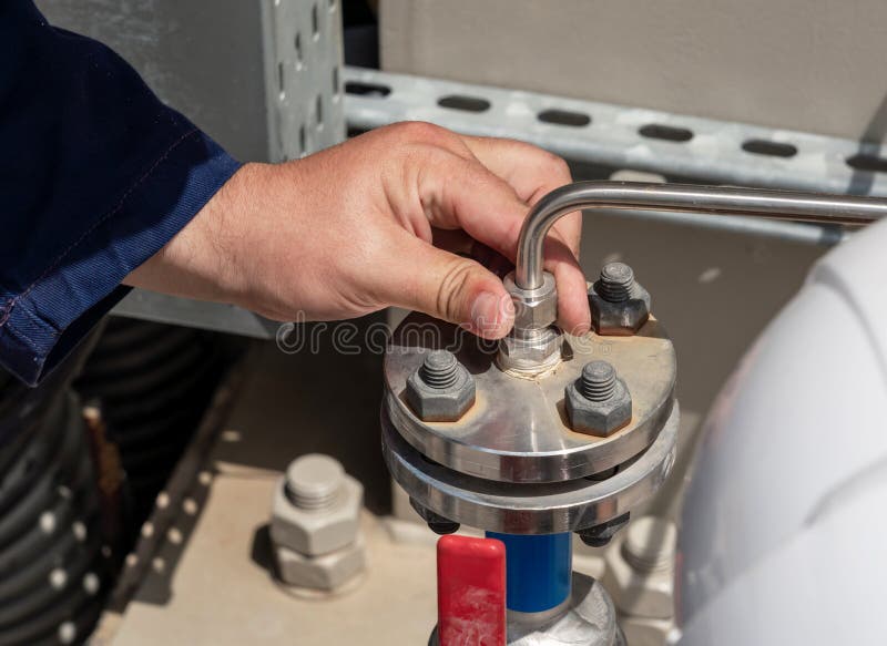 Close-up of an Engineer Adjusting a Pipeline Flange Connection ...
