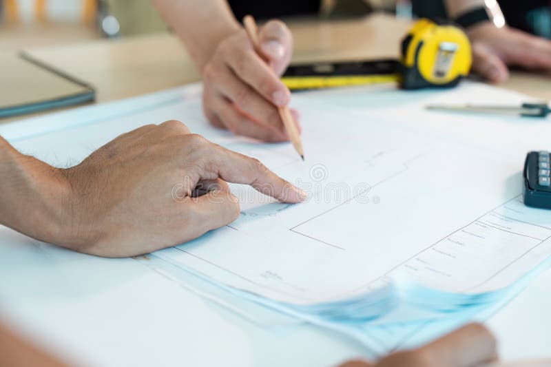 Engineer Working on Blueprint with Pencil and Measuring Tape in Modern ...