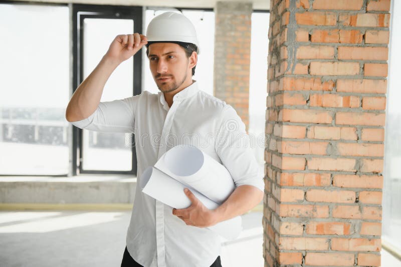 Close Up Engineers Working on a Building Site Holding a Blueprints ...