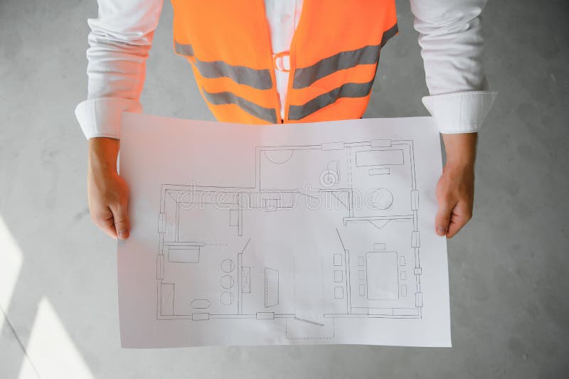 Close Up Engineers Working on a Building Site Holding a Blueprints ...