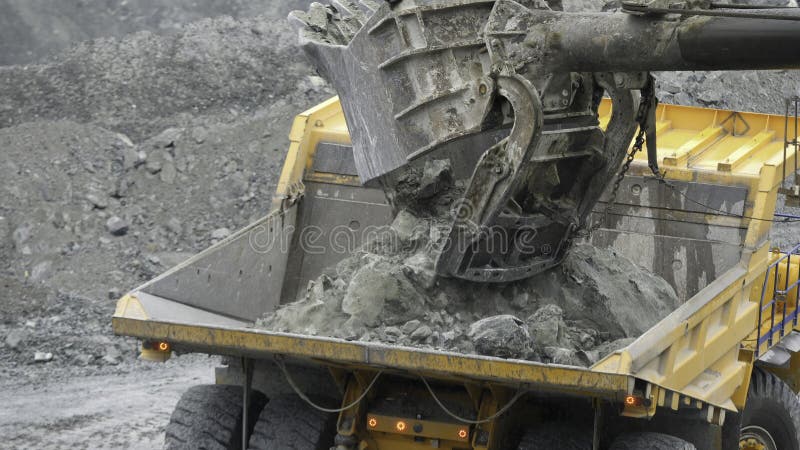 Close-up of Excavator Loading the Dumper with Ore in the Quarry. Mining ...