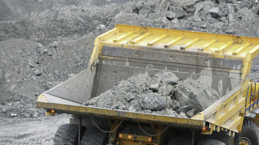 Close-up of Excavator Loading the Dumper with Ore in the Quarry. Mining ...