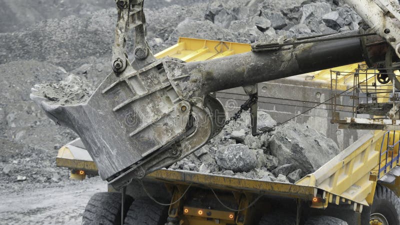 Close-up of Excavator Loading the Dumper with Ore in the Quarry. Mining ...