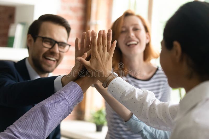 Close Up Diverse Employees Team Giving High Five Celebrating Success