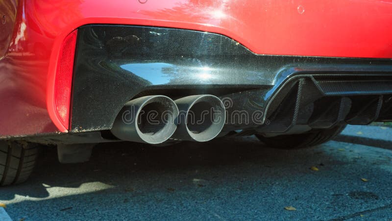 Close Up of Exhaust Pipe of a Red Car. Twin Exhaust Pipes Stock Image ...