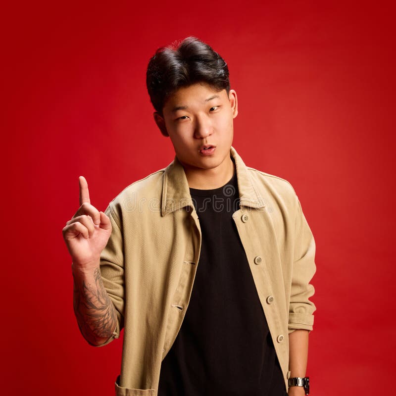 Close-up of Expressive Young Man Raising Finger with Assertive Look ...