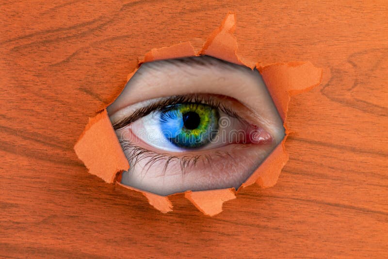 Close Up of Eye Looking through the Torn Paper Hole Stock Image - Image ...