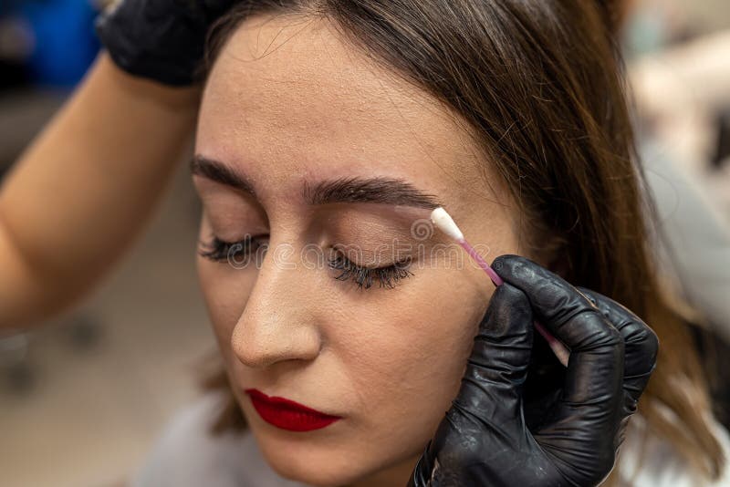 Close-up of an Eyebrow Designer Correcting and Touching Up Eyebrows ...