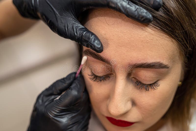 Close-up of an Eyebrow Designer Correcting and Touching Up Eyebrows ...
