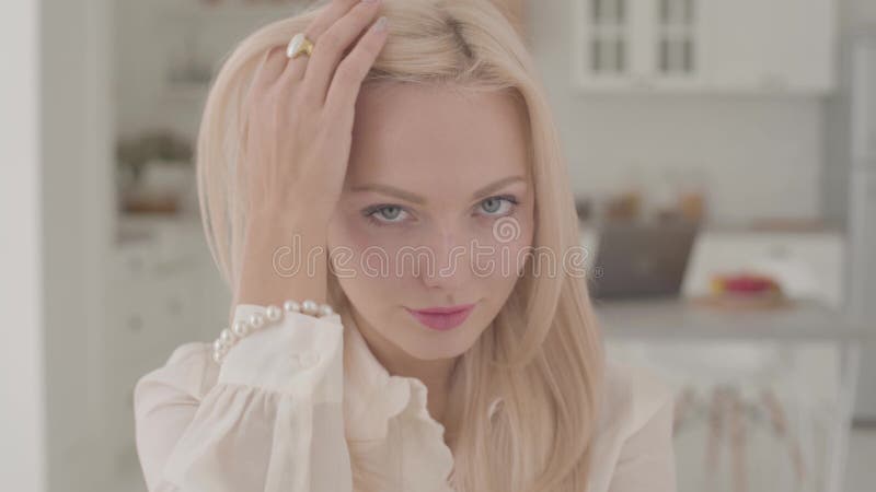 Gorgeous Caucasian Woman With Blond Hair And Grey Eyes Looking At Her