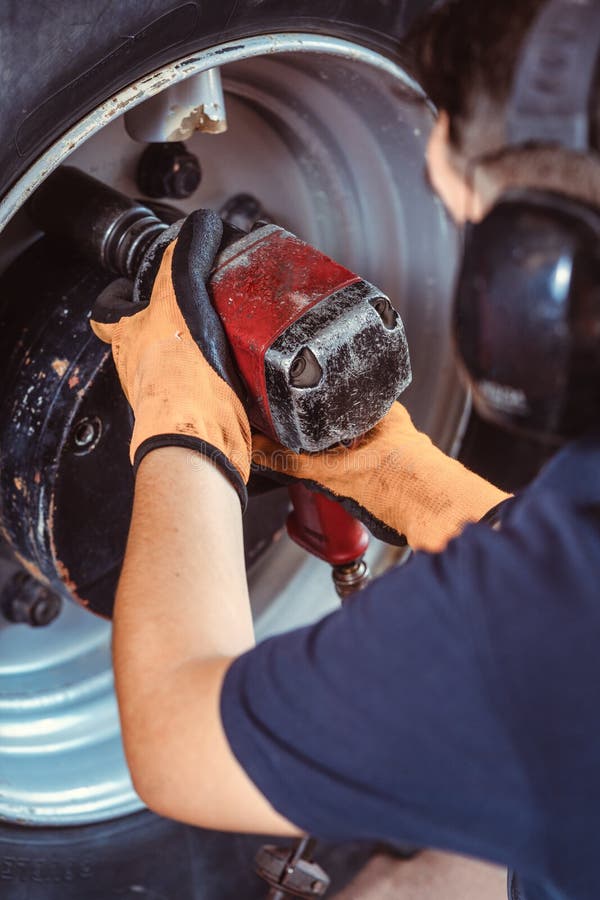 Close-up of Farm Machine Mechanic Working on Wheel Stock Photo - Image ...