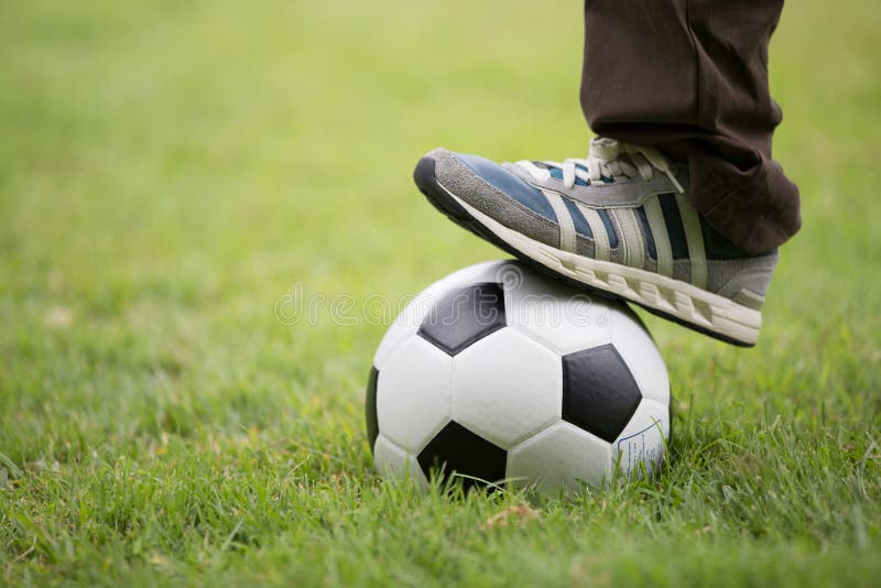 Close Up of Feet on Top of Soccer Ball Stock Image - Image of field ...
