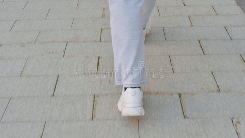 Close Up of Feet of Young Woman Walking on Pavement, Back View Stock ...