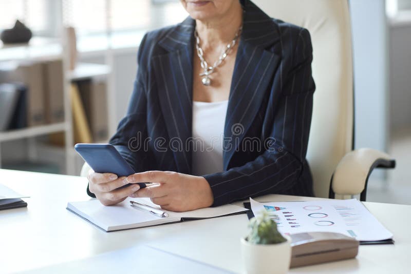 Close Up of Female Boss Using Smartphone at Workplace in Office Stock ...