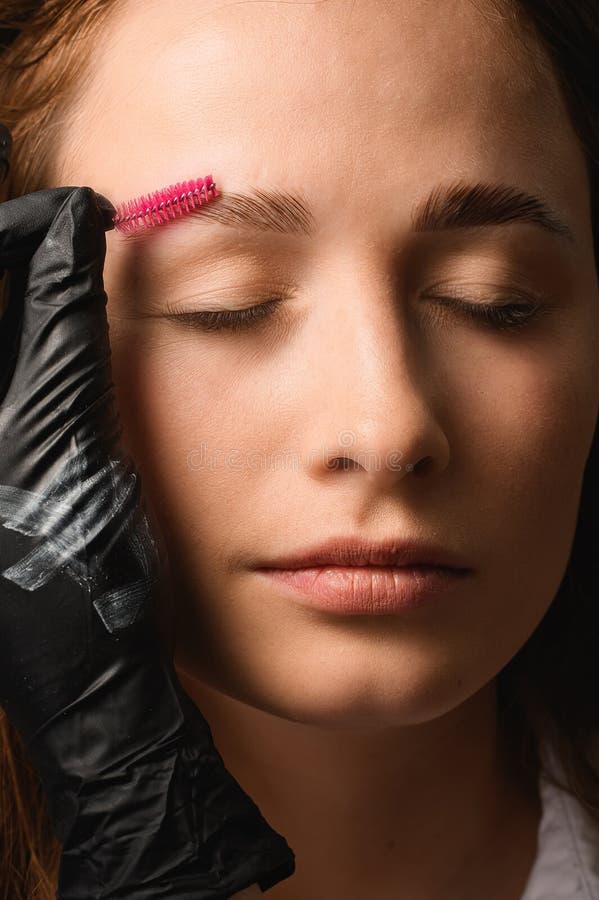 Close-up of Female Face on Which Combs Eyebrows with Brush. Stock Photo ...