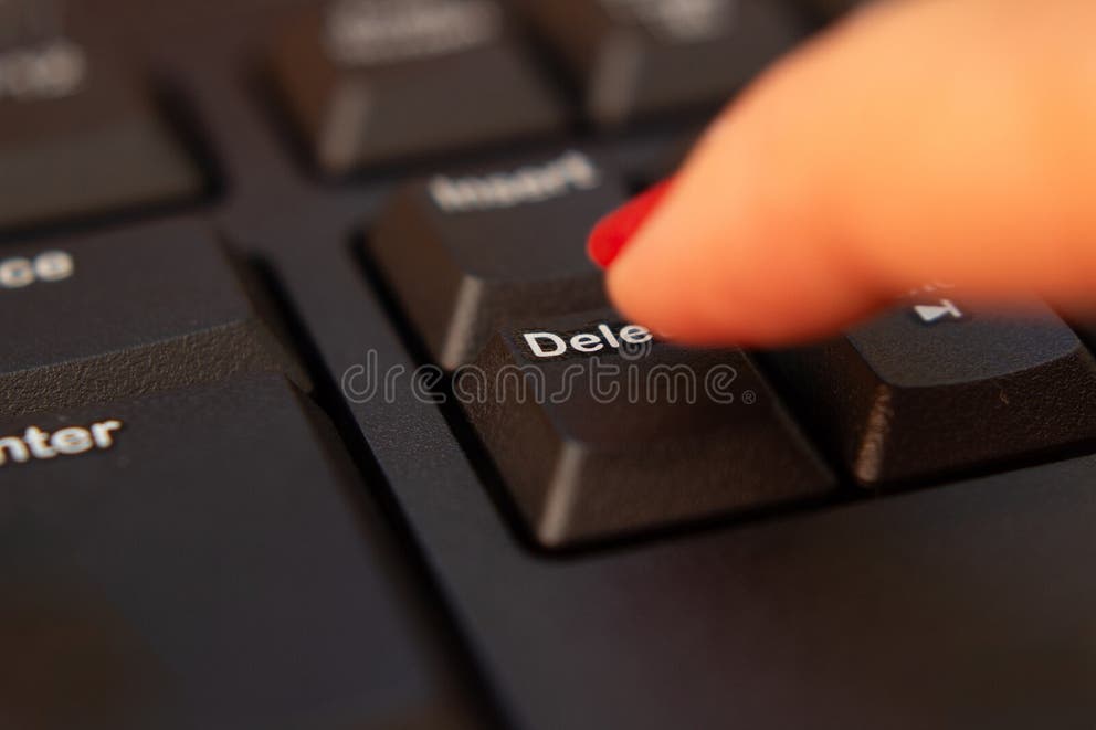 Close Up of Female Finger Pressing the Delete Key. Stock Photo - Image ...