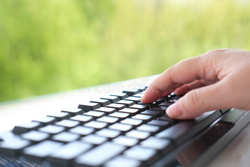 Close-up Female Hand Typing Text on a Computer Keyboard on a Natural ...