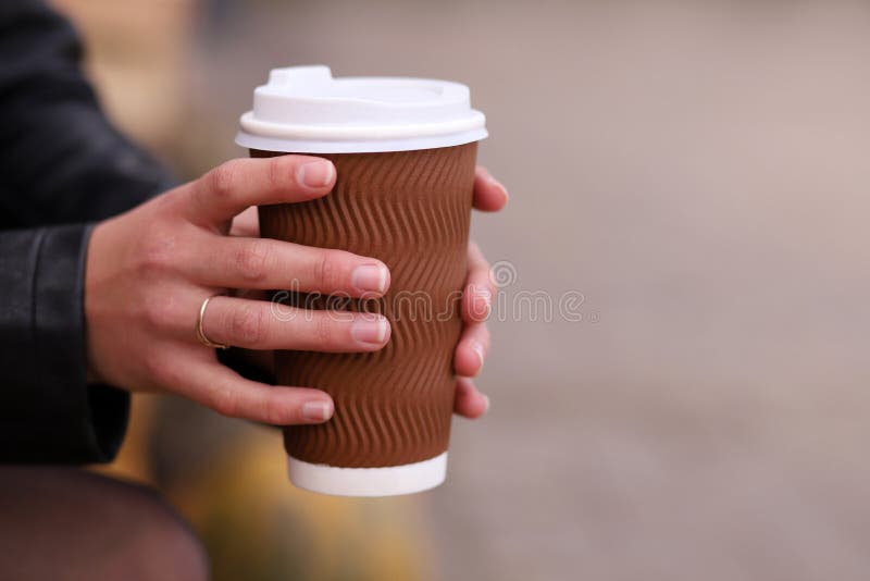 Close-up of Female Hands Holding a Large Plastic Disposable Cup with ... Close-up of Female Hands Holding a Large Plastic Disposable Cup with ...
