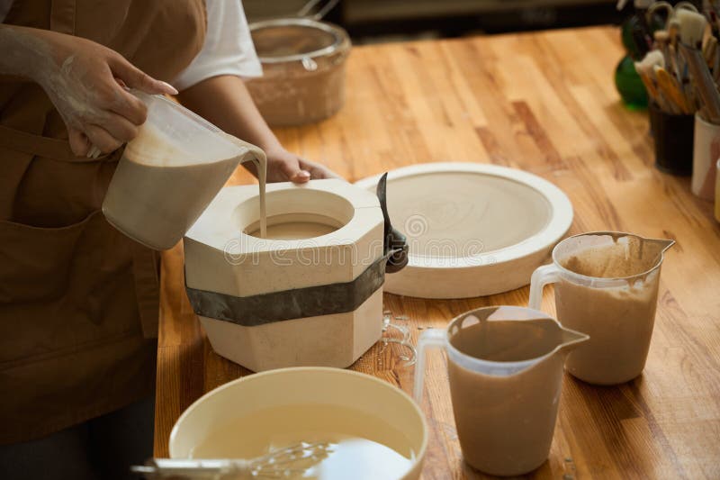 Close Up of Female Hands Holding Mold for Mug while Pouring Pottery ...