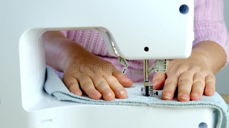 Close-up of Female Hands Perform Work on a White Sewing Electric ...