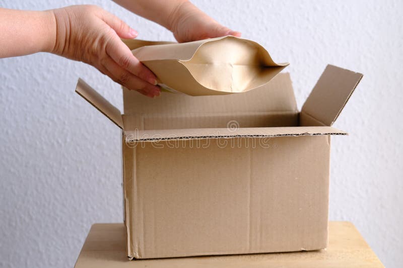 Close-up of Female Hands Take Out Package from Open Cardboard Box of ...