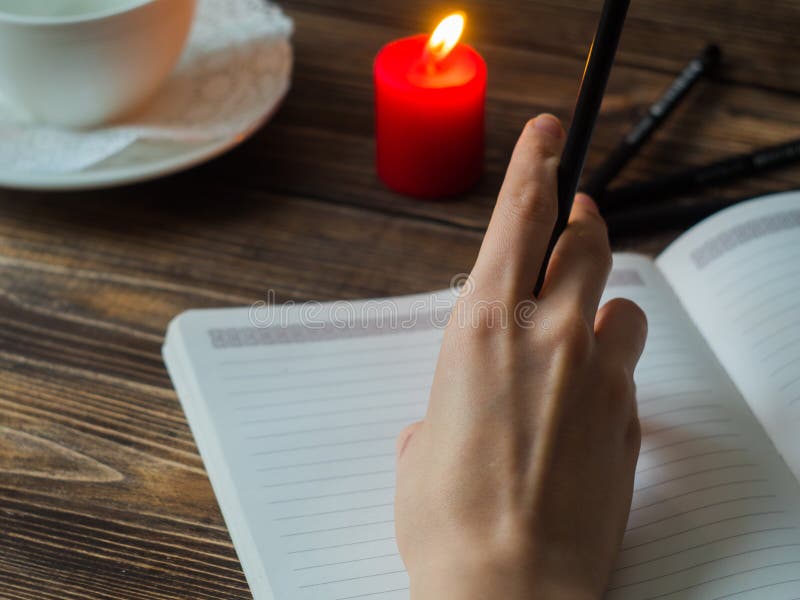 Close Up of Female Hands Writing with Pencil at Cafe with Burning ...