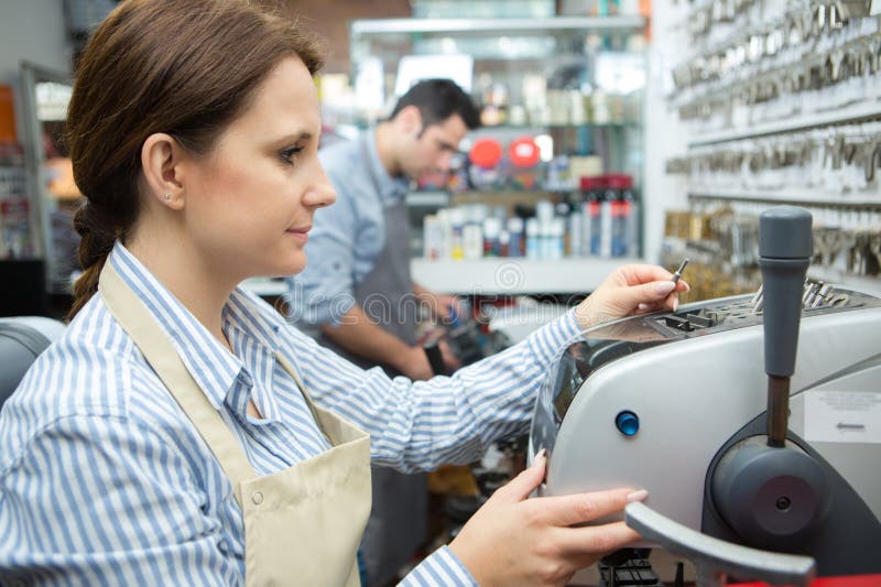 Close up female key maker stock photo. Image of factory - 308150454