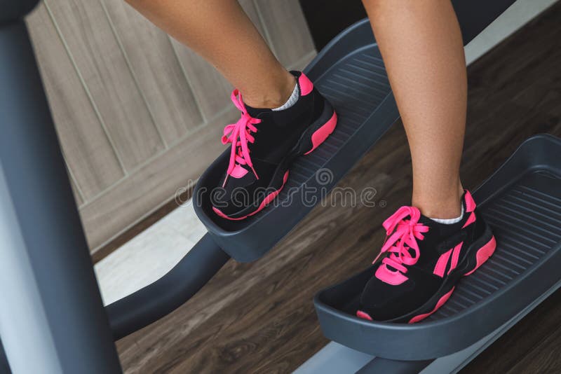 Female Legs on a Elliptical Trainer in the Gym Stock Image - Image of ...