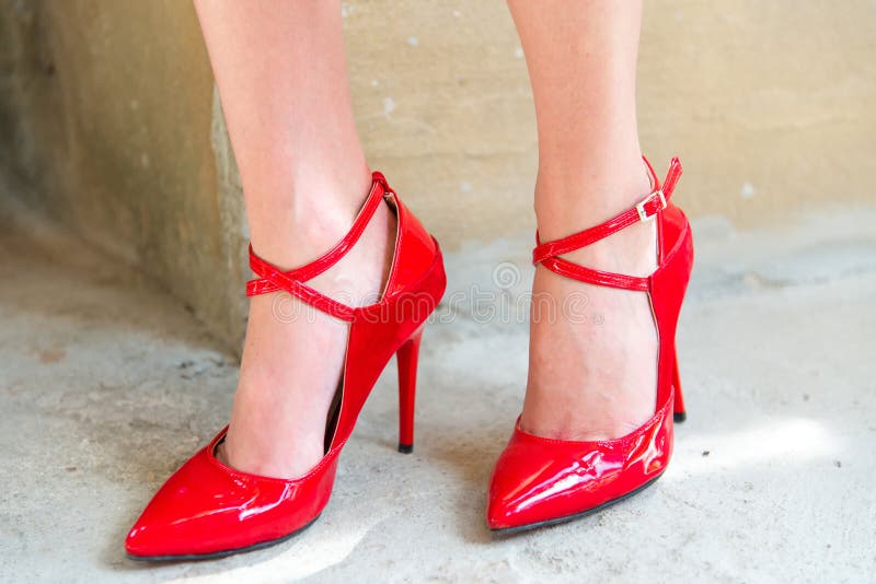 Female Legs in Bright Red Shoes with High Heels Against the Pavement ...