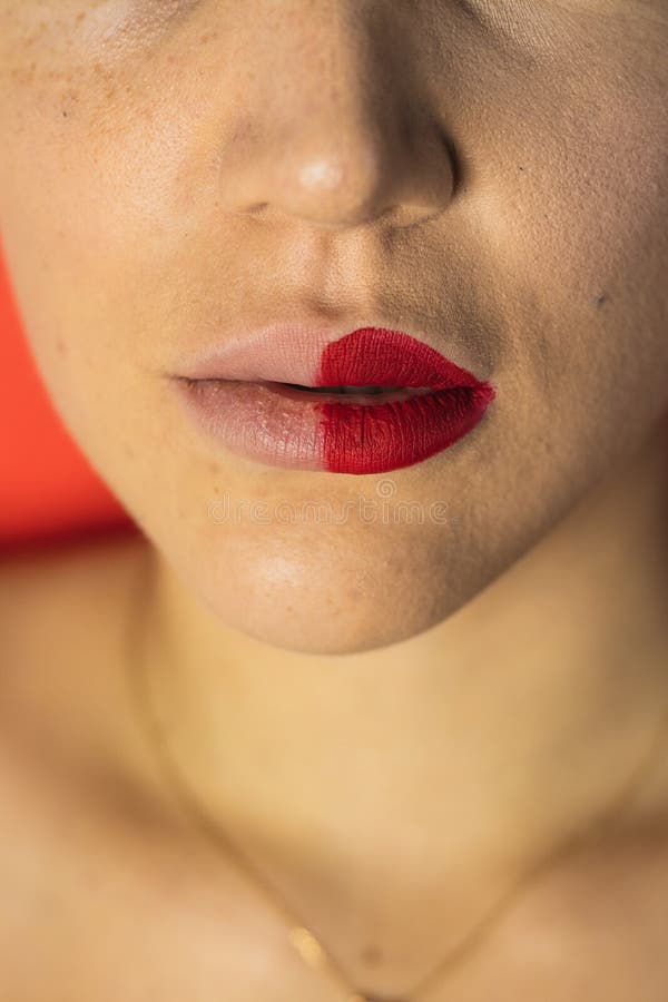 Close Up of Female Lips with Two Different Lipsticks. Red Background ...